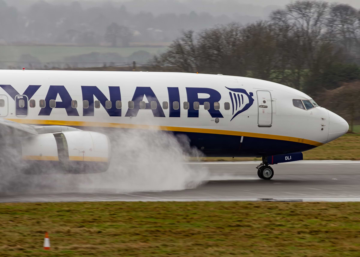 'Ryanair plane on wet runway' Poster, picture, metal print, paint by ...