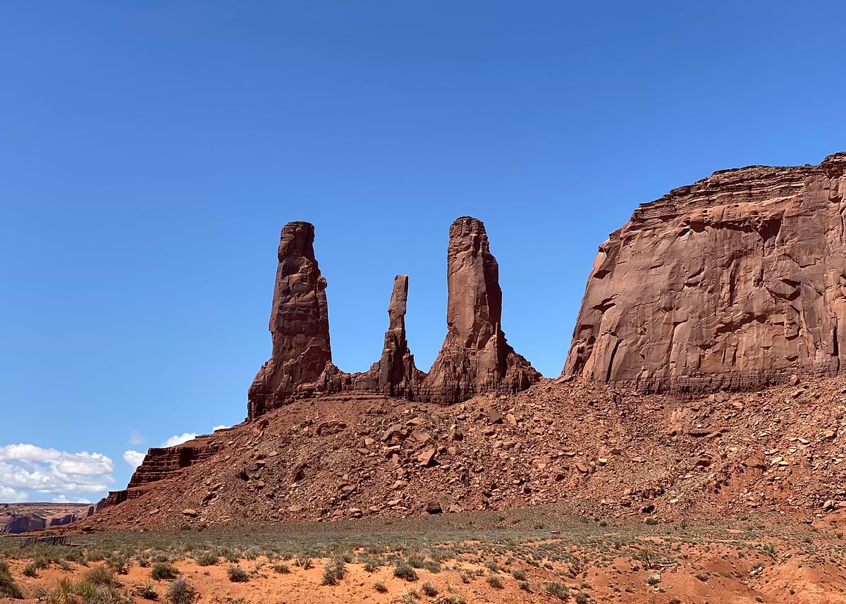 'Monument Valley Three Sisters rock formations under blue sky' Poster ...