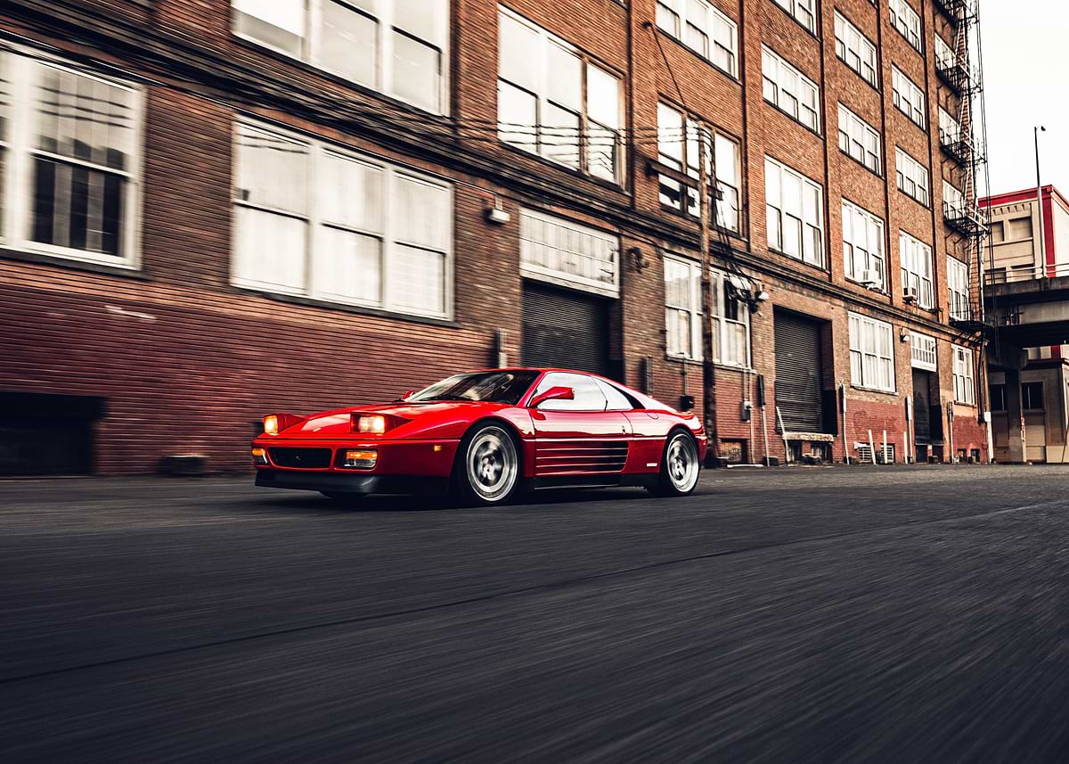 'Red Ferrari driving down urban street' Poster, picture, metal print ...
