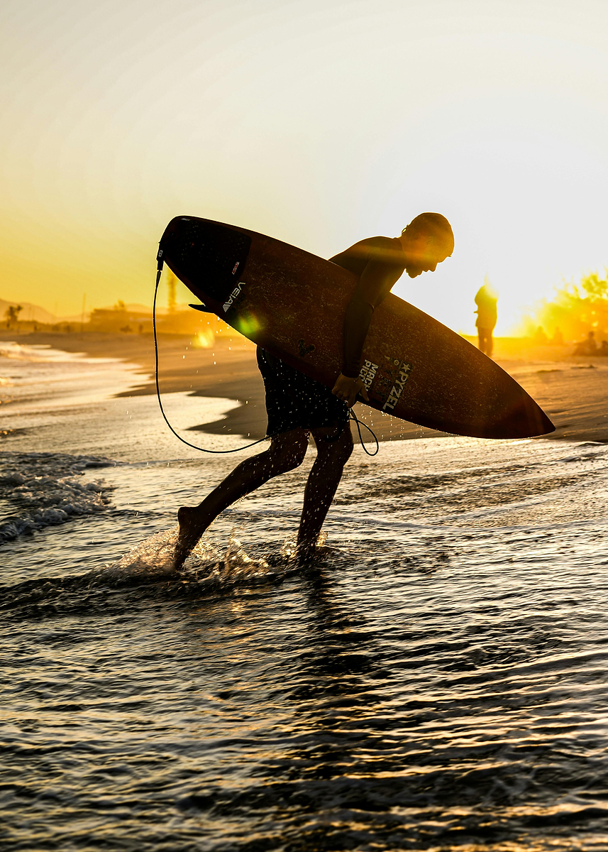 'Surfer silhouette at sunset on beach' Poster, picture, metal print, paint by Moments | Displate